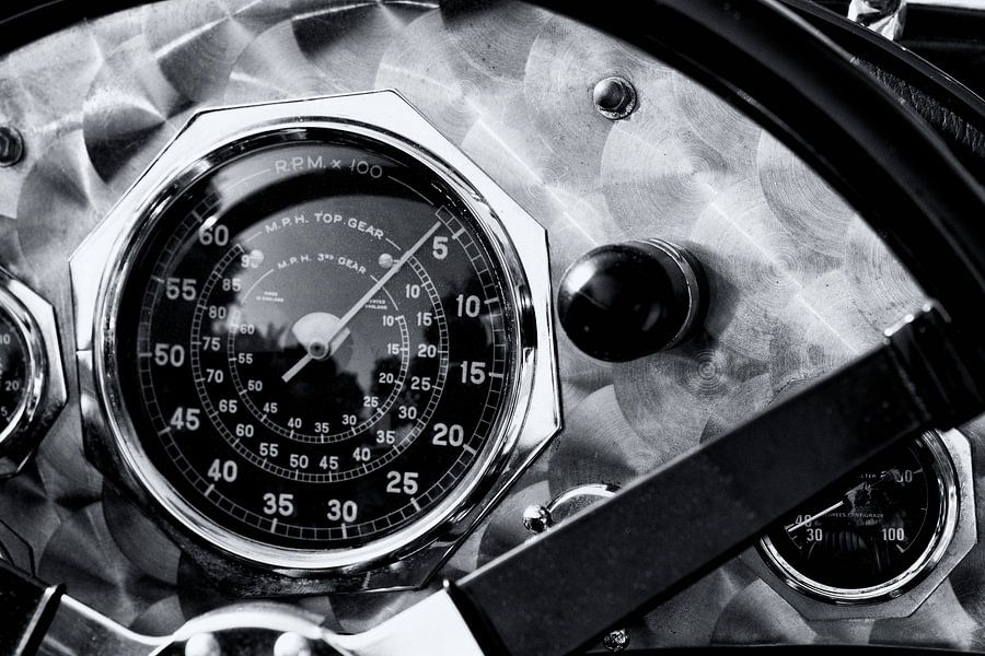 Brushed aluminium dashboard with speedometer on a vintage 1920s British ...